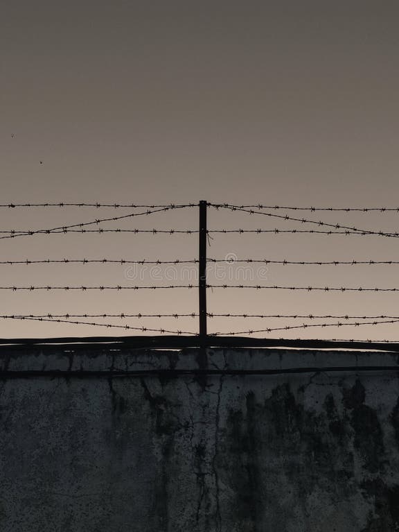 Walls and Barbed Wire between Evening and Night Stock Image - Image of ...