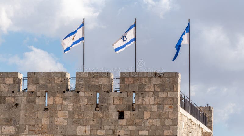 Three Flags Flying in the Wind Atop a Stone Castle Wall Stock Photo ...