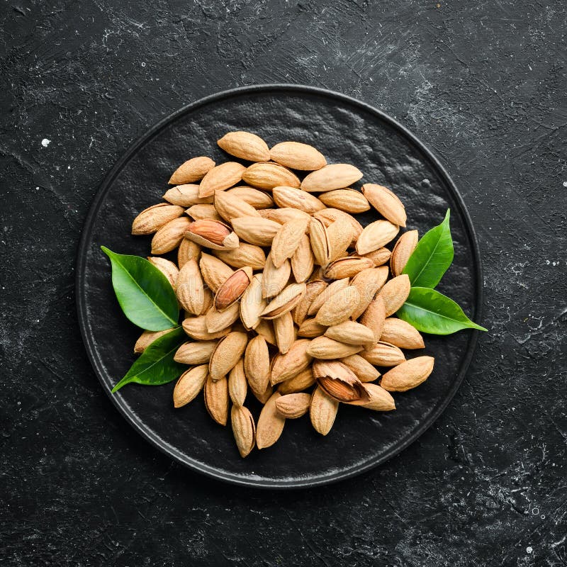 Walnut Almonds in the Shell. Nuts on a Black Stone Background. Top View ...