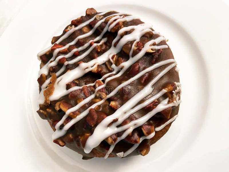 Walnut and Chocolate Donut with White Icing Stock Photo - Image of ...
