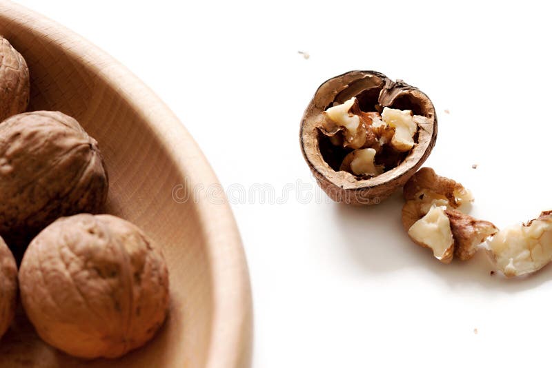 Walnut Cracked Open with Several Whole Walnuts on White Background ...