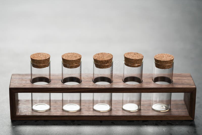 Walnut Holder with Glass Tubes for Spices on Concrete Surface Stock ...