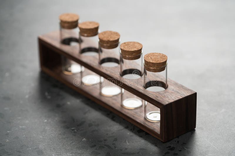 Walnut Holder with Glass Tubes for Spices on Concrete Surface Stock ...