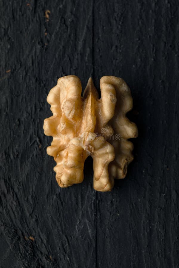 Walnut Kernel on Black Wood Stock Photo - Image of healthy, still ...