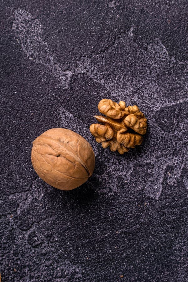 Walnut Kernel and Whole Walnut on Blue Slate Surface. Healthy Nuts and ...