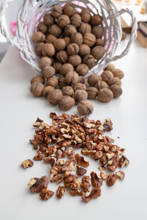 Walnut Kernels and Whole Walnuts on a White Table. Stock Photo - Image ...