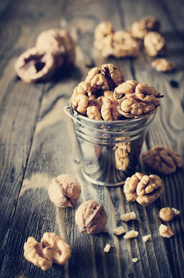 Walnut Kernels and Whole Walnuts on Wooden Table Stock Photo - Image of ...