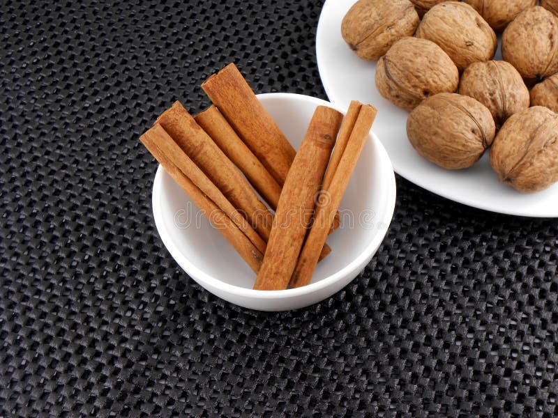 Walnut Set and Cinnamon Set on White Plate Stock Photo - Image of glass ...