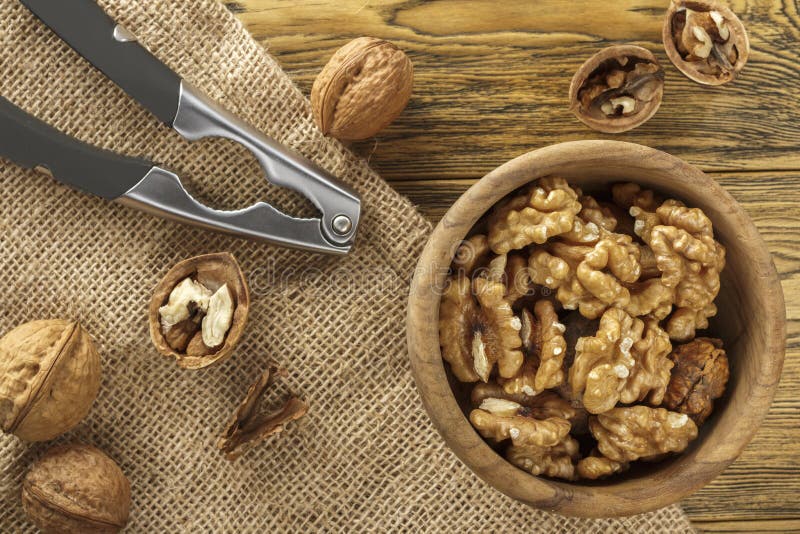 Walnut, Shell Cleaning Process. Natural Product on a Wooden Table Stock ...