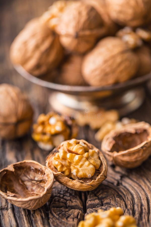 Walnut. Walnut Kernels and Whole Walnuts on Rustic Old Oak Table Stock ...