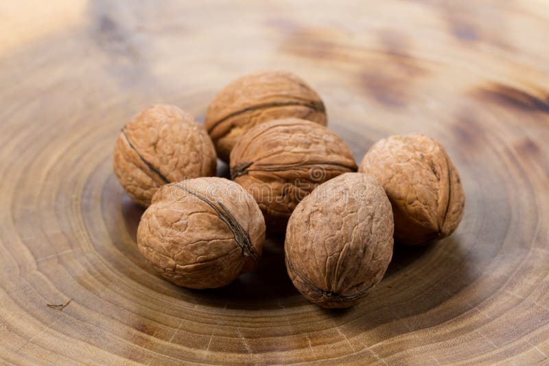 Walnuts Close-up on a Table from a Cut of a Poplar Trunk, Growth Rings ...