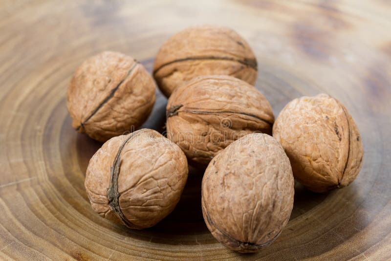 Walnuts Close-up on a Table from a Cut of a Poplar Trunk, Growth Rings ...