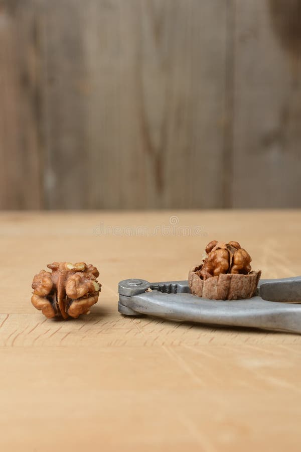 Walnuts Cracked Open with a Wooden Nut Cracker Stock Photo - Image of ...