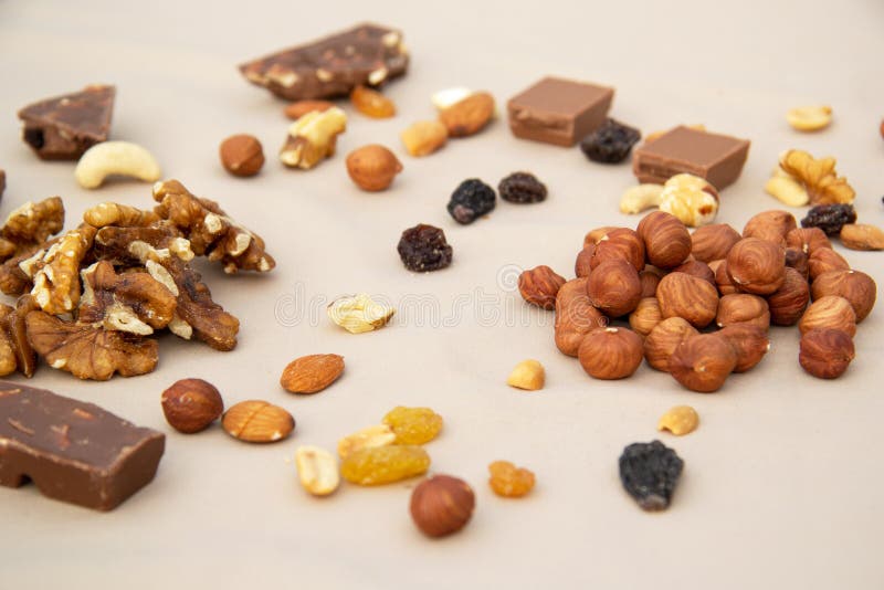 Walnuts, Peanuts, Almonds, Raisins, Pieces of Chocolate Lie on a Light ...