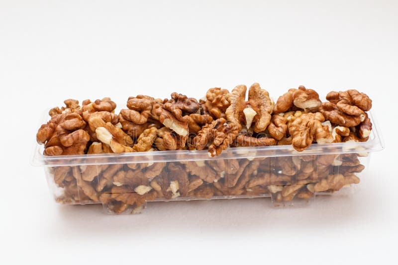 Walnuts in a Plastic Container on the White Background Stock Photo ...