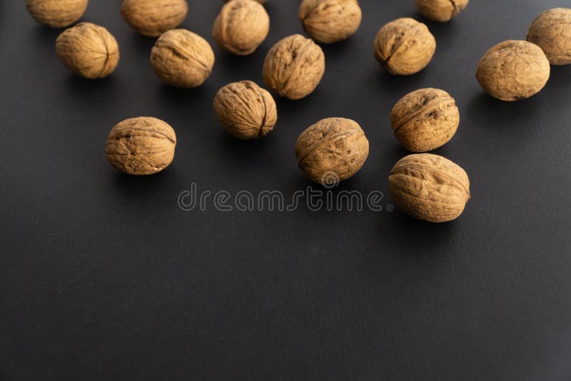 Walnuts in Shell on Black Surface, Side View. Healthy Nuts and Seeds ...