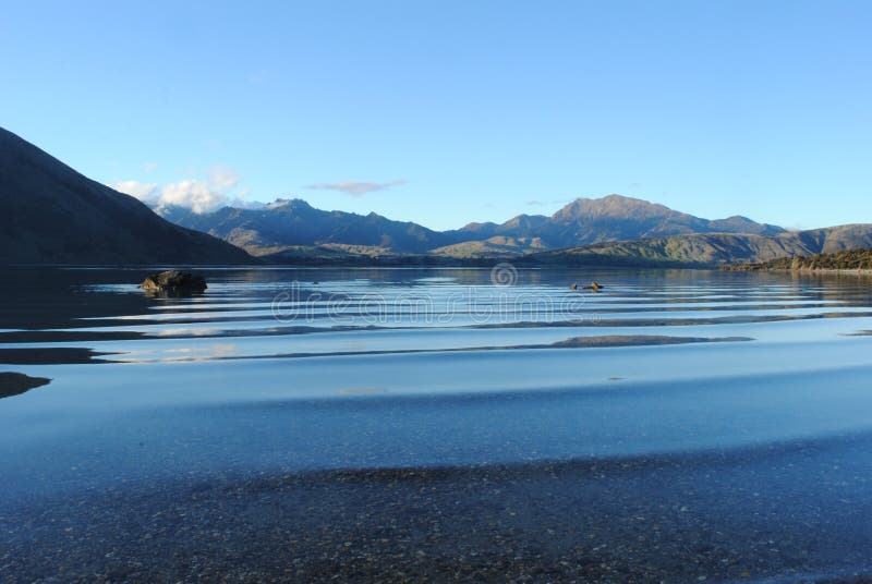 Lakeside ripple stock photo. Image of horizon, mountain - 260490852