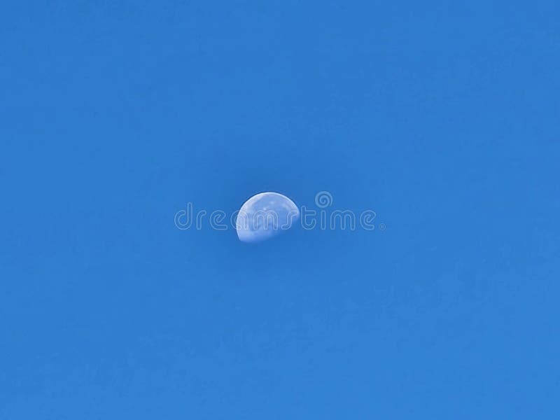 The Waning Moon Hovers in the Blue Sky, Discreet and Luminous. Stock ...