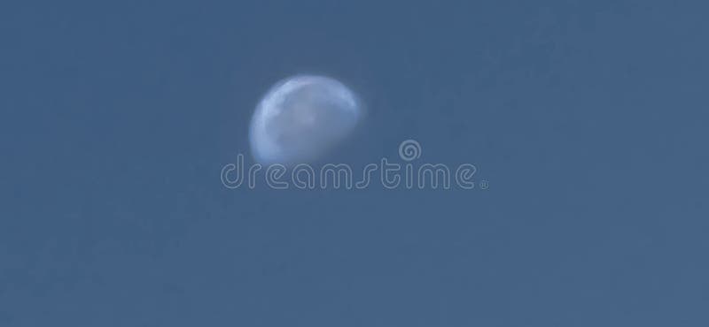 The Waning Moon Softly Shines in the Blue Sky, Contrasting with the Sun ...