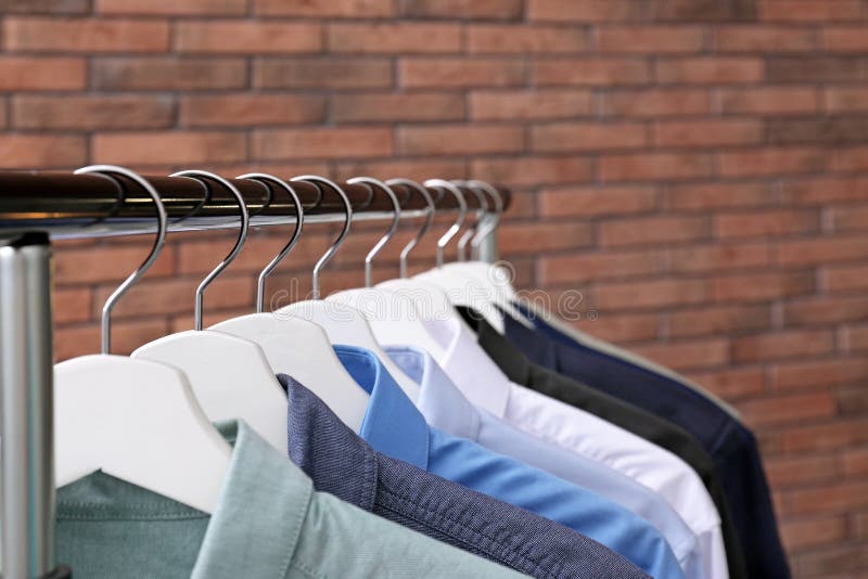 Wardrobe Rack with Stylish Clothes Near Brick Wall, Closeup Stock Image ...