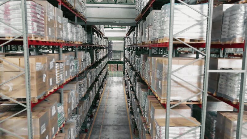 Warehouse Aisle with Stacked Pallets and Boxes in Storage Racks Stock ...