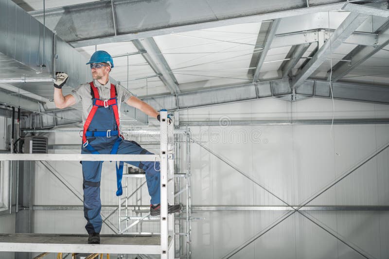 Warehouse Building Specialist Performing Examination Using Scaffolding ...