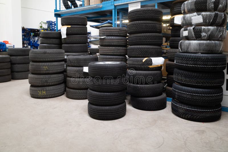 In a Warehouse of a Car Repair Shop are Several Stacks of Summer Wheels ...