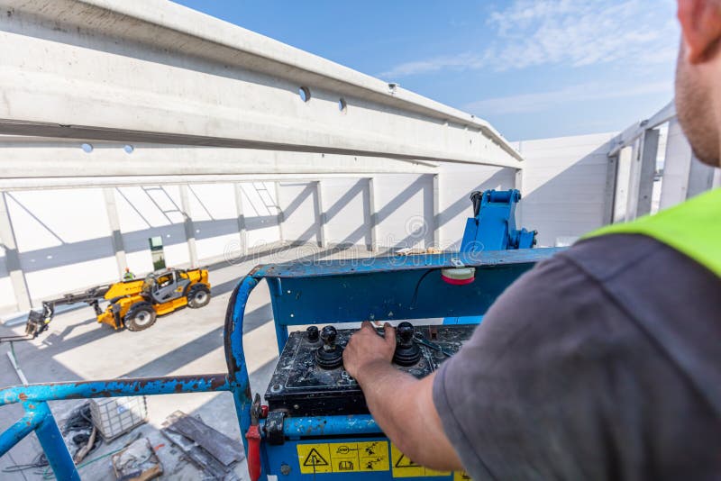 Warehouse Construction. Worker on Mobile Elavating Work Platform Stock ...
