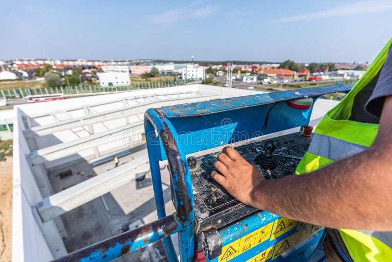 Warehouse Construction. Worker on Mobile Elavating Work Platform Stock ...