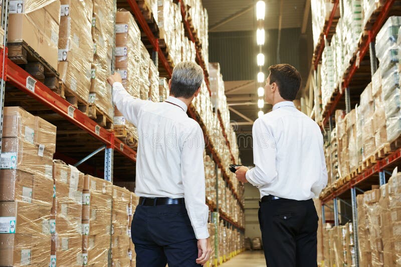 Businessman and Female Worker in Distribution Warehouse Stock Photo ...