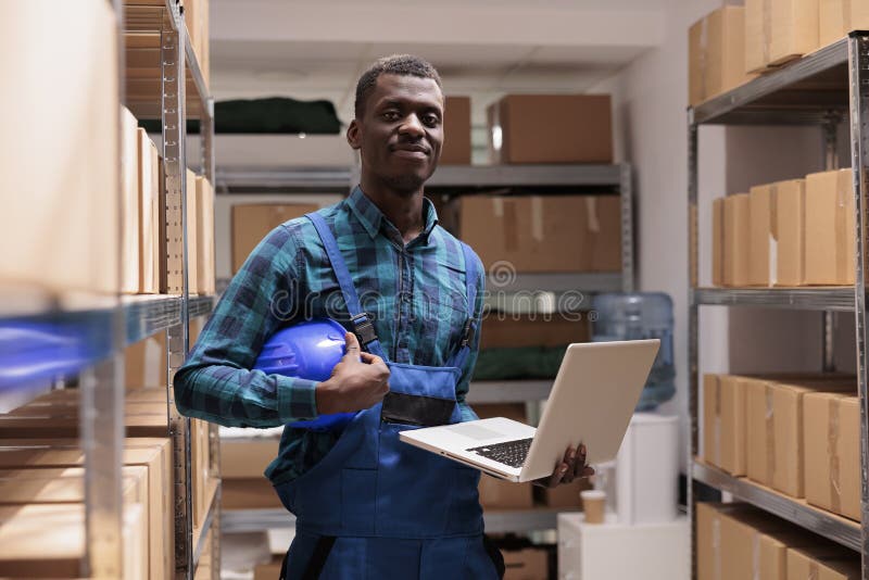 Warehouse Employee Doing Inventory Management Using Laptop Stock Photo ...