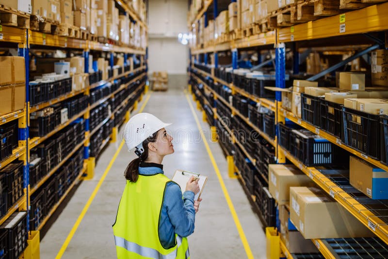 Warehouse Female Worker Checking Up Stuff in a Warehouse. Stock Image ...