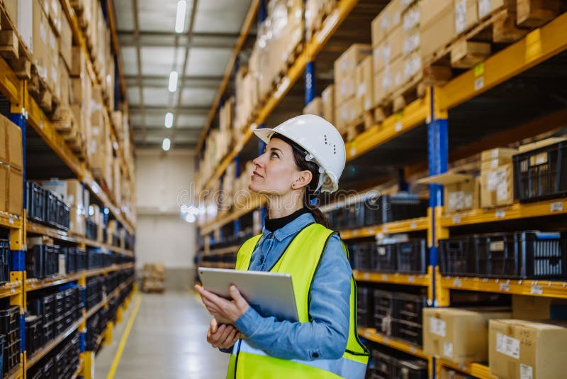 Warehouse Female Worker Checking Up Stuff in a Warehouse. Stock Photo ...