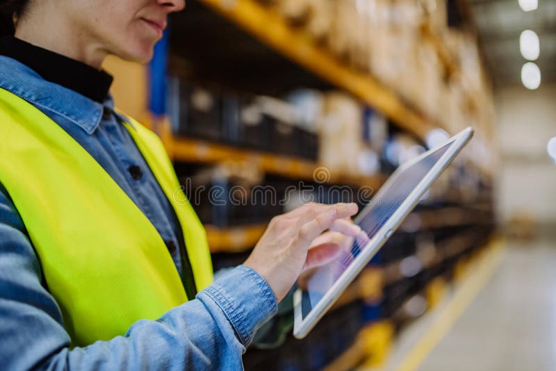 Warehouse Female Worker Checking Up Stuff in a Warehouse. Stock Image ...