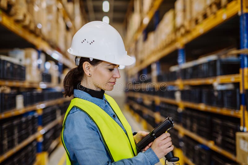 Warehouse Female Worker Checking Up Stuff in a Warehouse. Stock Image ...