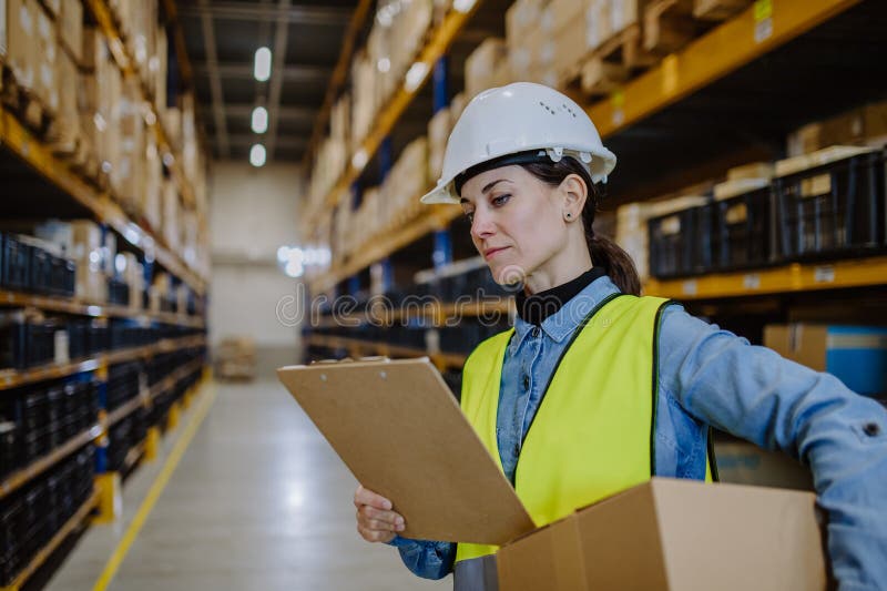 Warehouse Female Worker Checking Up Stuff in a Warehouse. Stock Image ...