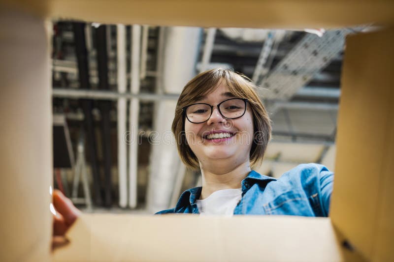 Warehouse Female Worker Looking through an Empty Box Stock Image ...