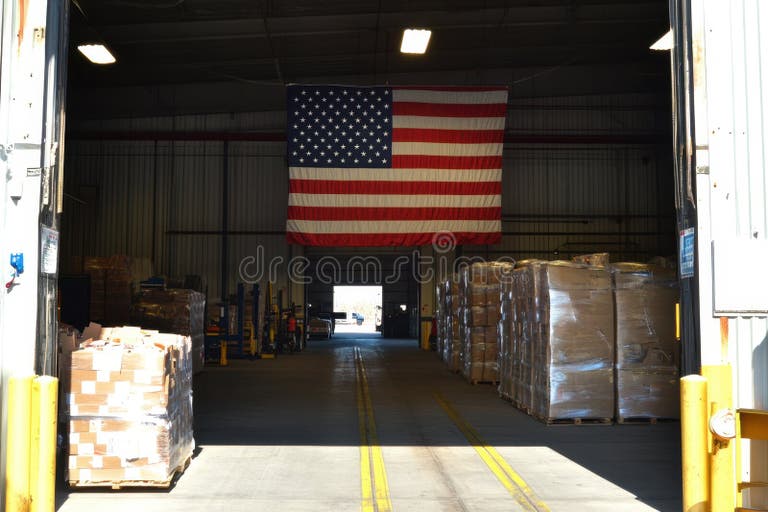 Warehouse Interior with Stacked Boxes and Large American Flag Displayed ...