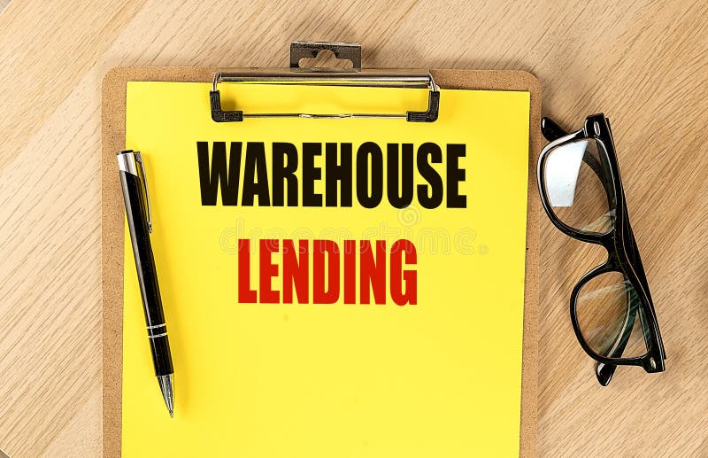 WAREHOUSE LENDING Text on Yellow Paper on Clipboard with Pen and ...
