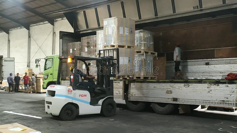 Warehouse Loading: Forklift and Truck Efficiently Transporting Packages ...
