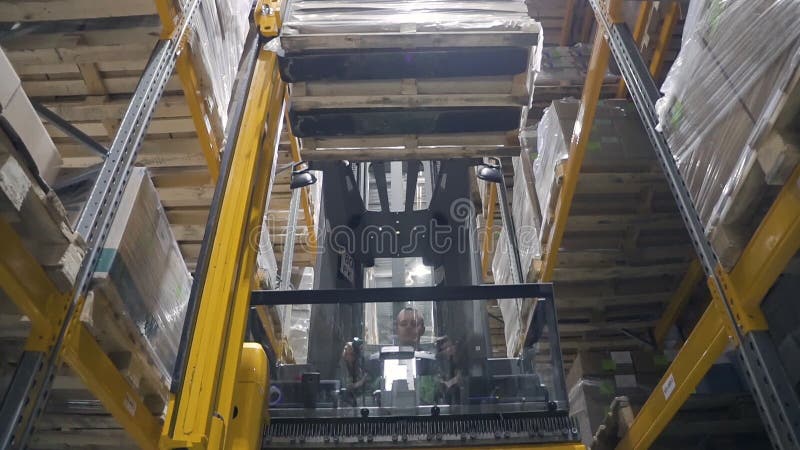 Warehouse Male Worker at Forklift. Loader Unload Goods from Shelf Stock ...