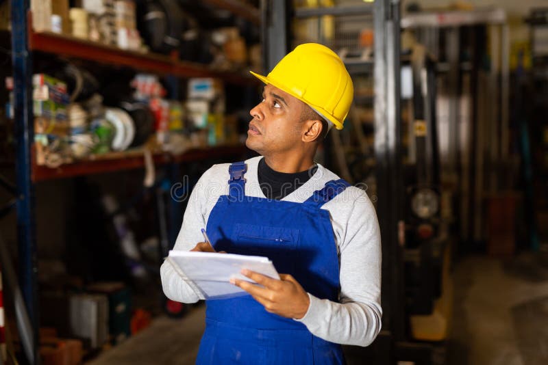 Warehouse Manager Calculates the Quantity of Goods and Writes it Down ...