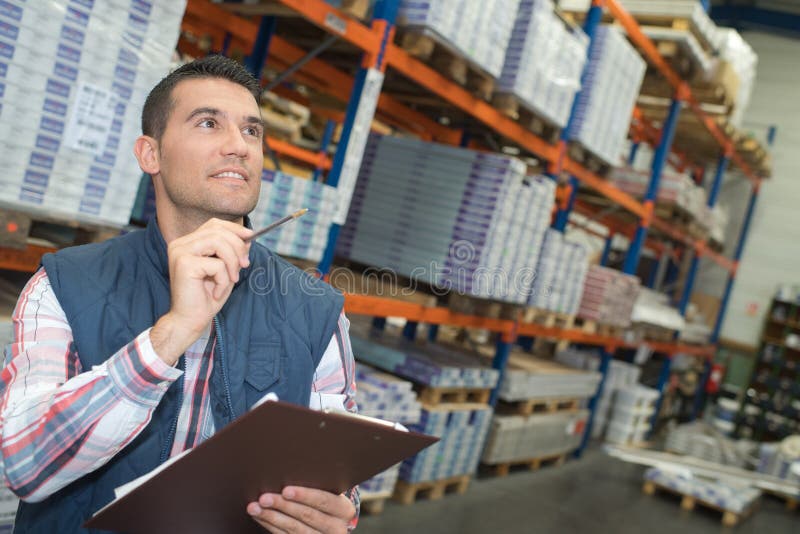 Warehouse Manager Checking Inventory in Large Warehouse Stock Image ...