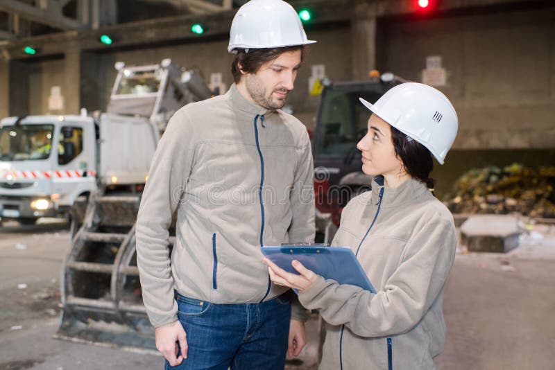 Warehouse Manager and Colleague Talk by Recycling Machinery Stock Photo ...