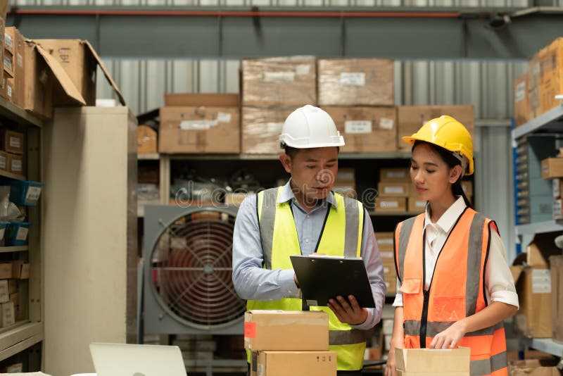 Warehouse Manager with Female Assistant Rethink a Plan To Prepare Items ... Warehouse Manager with Female Assistant Rethink a Plan To Prepare Items ...