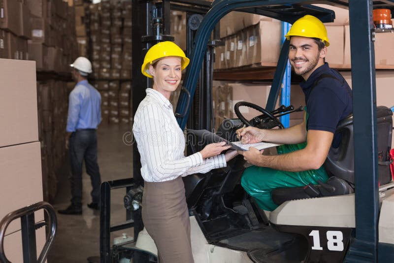 Warehouse Manager Smiling at Camera with Forklift Driver Stock Photo ...