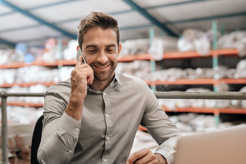 Warehouse Manager Talking on a Cellphone in His Office Stock Photo ...