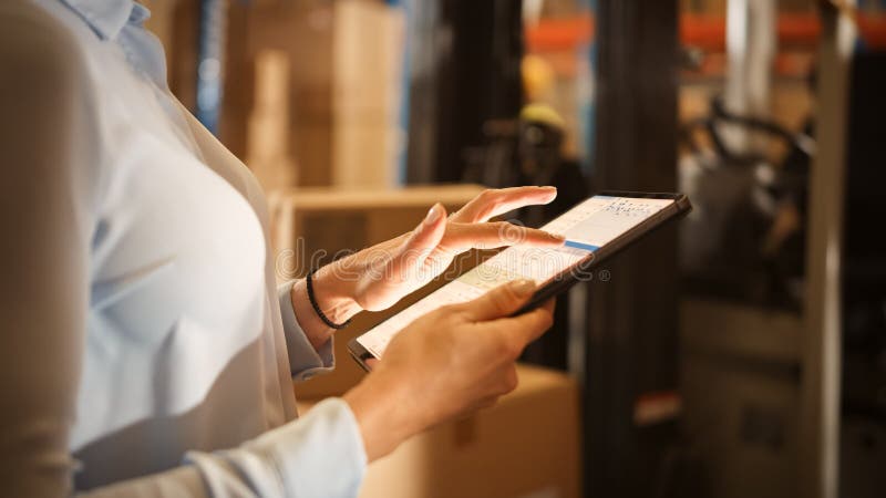 In Warehouse Manager Uses Digital Tablet with App To Check Package ...