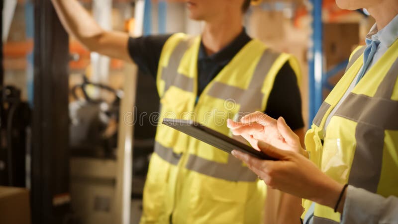 In Warehouse Manager Uses Digital Tablet and Talks with Forklift Driver ...