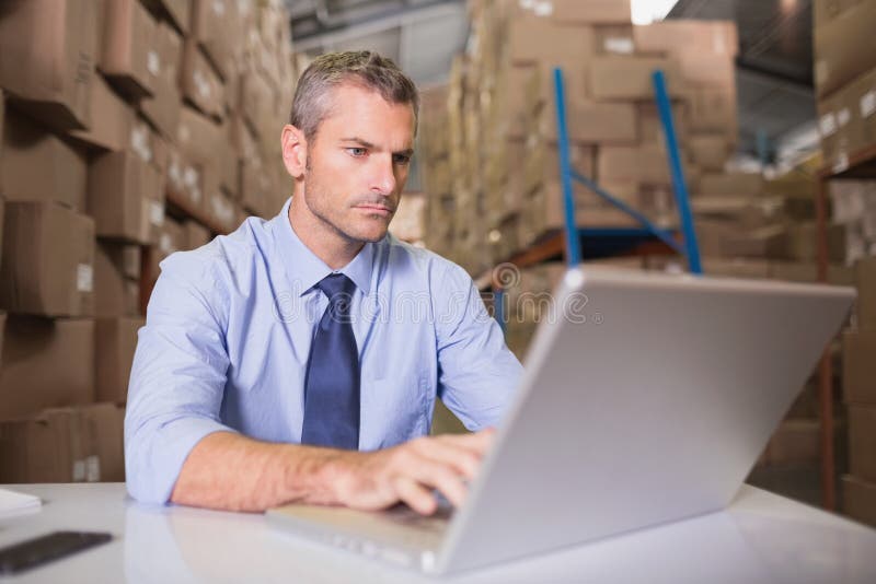 Warehouse Manager Using Laptop Stock Photo - Image of adult, male: 57326742